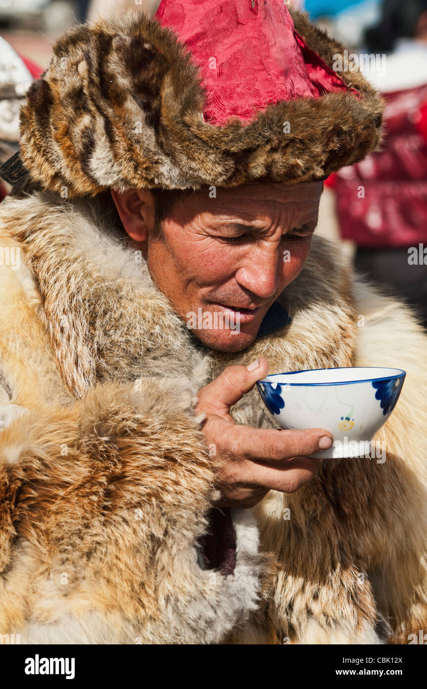 Kazakh eagle hunter drinking milk tea in the Altai Region of Bayan ...