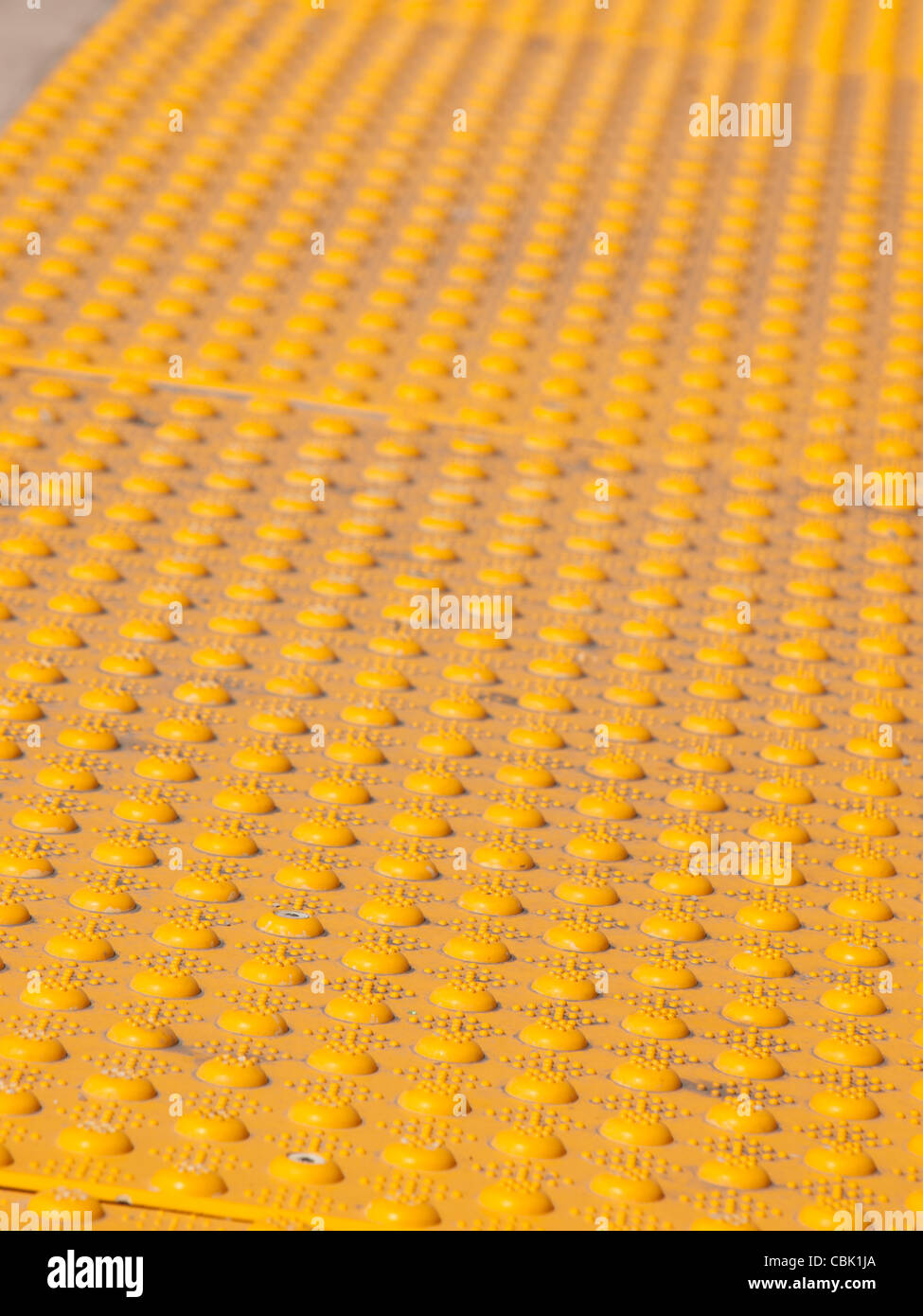 Colored flooring with bumpy texture used to indicate a crossing ...