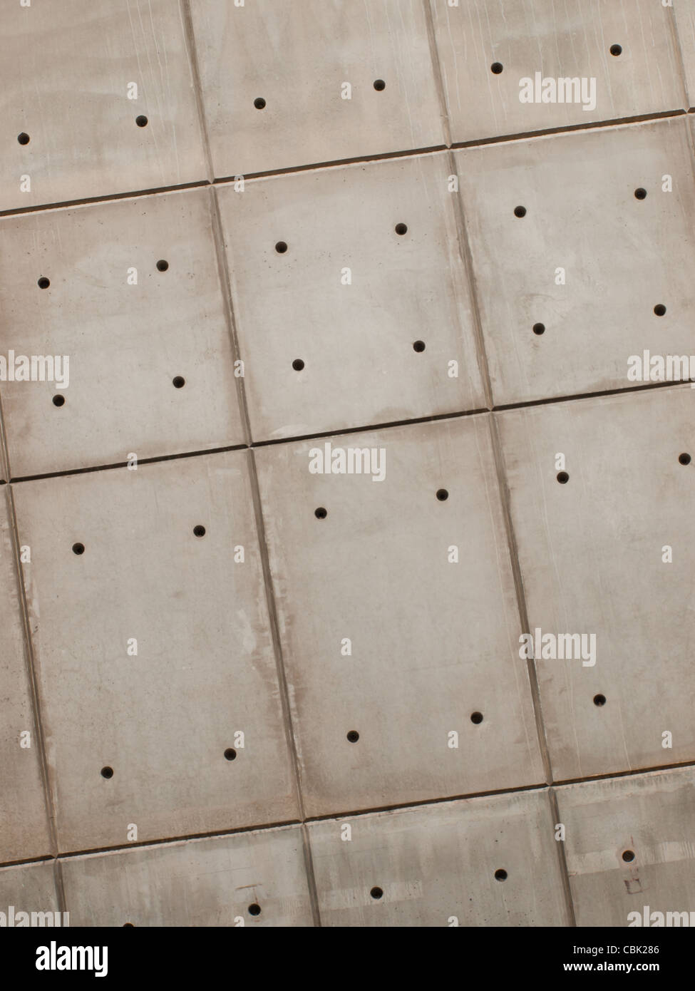 Raw concrete wall background with formwork lines and tie hole plugs ...