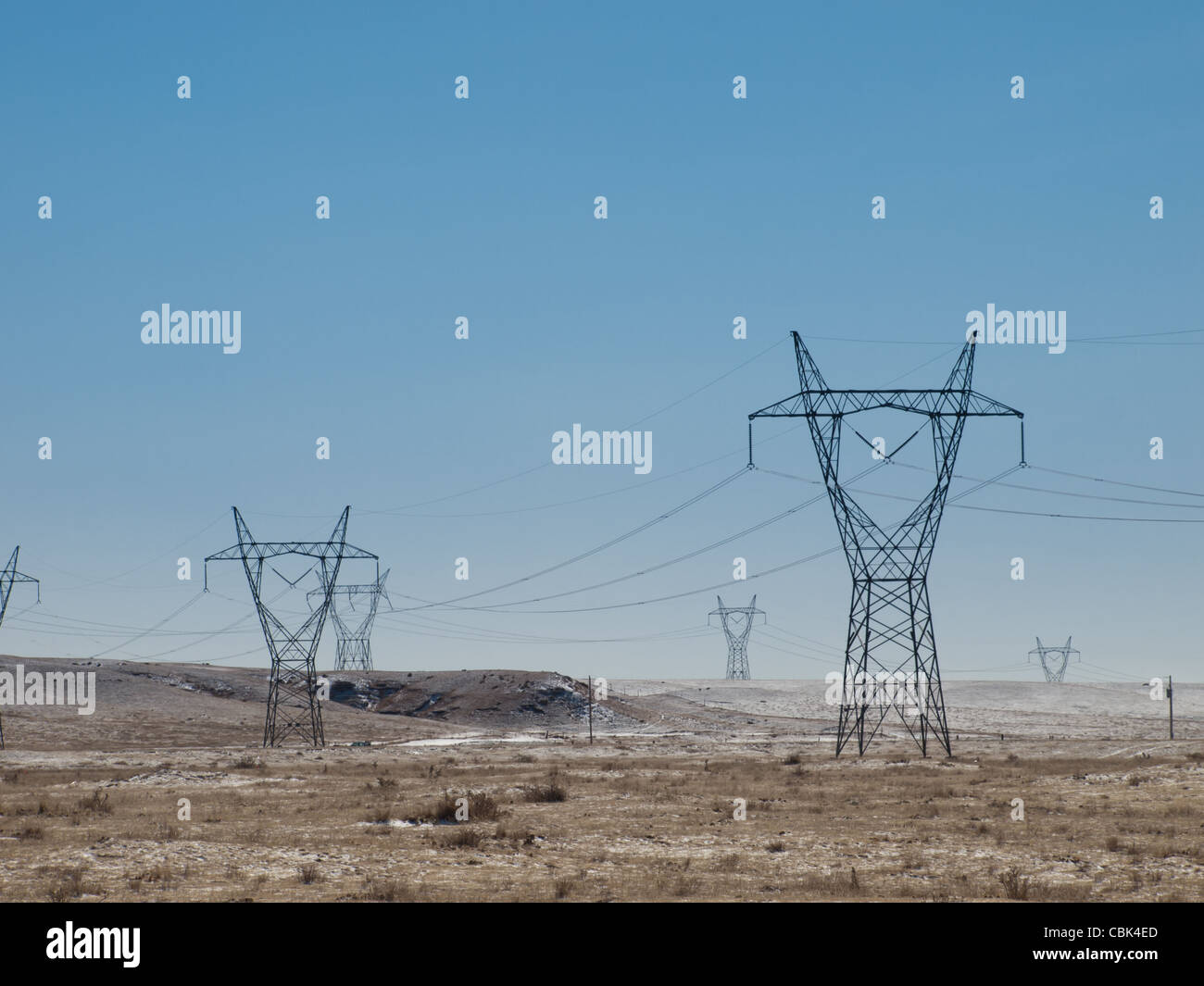 Long lines of powerline towers stretching across a countryside in Fort ...
