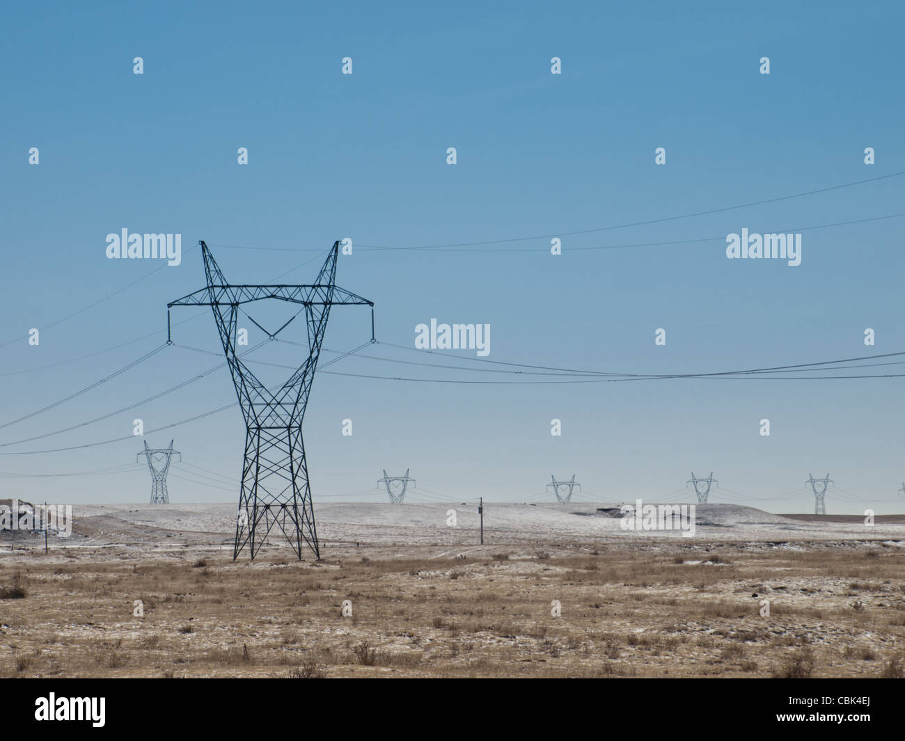 Long lines of powerline towers stretching across a countryside in Fort ...