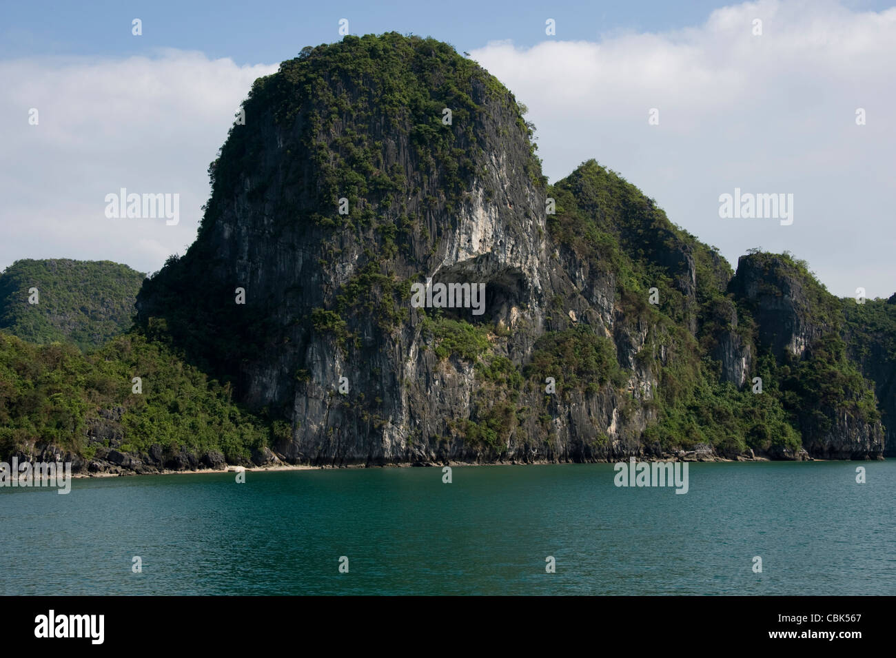 View on one of the many islands in Ha Long Bay - mountain with a cave ...