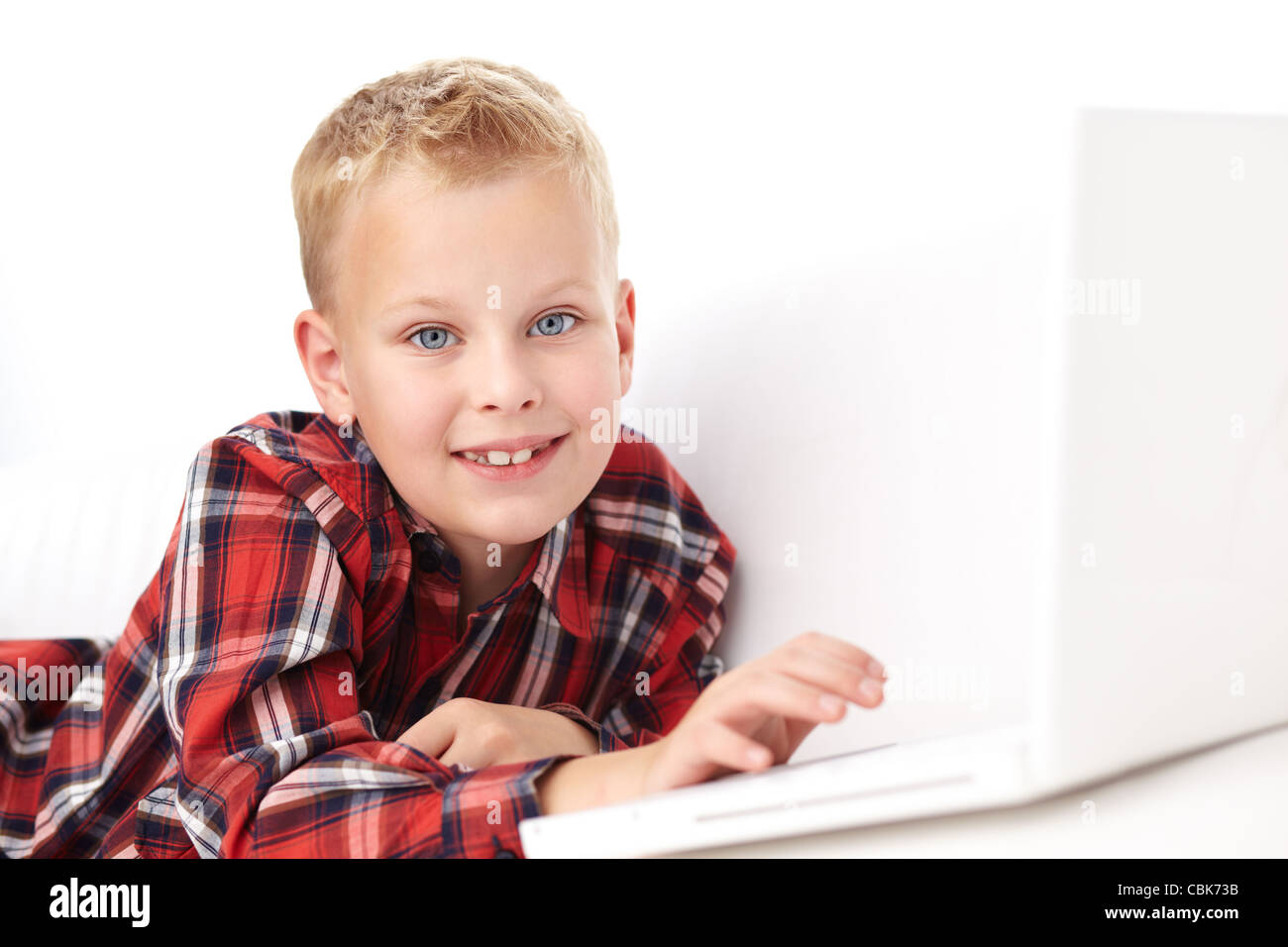 Portrait of cute boy typing and looking at camera Stock Photo - Alamy
