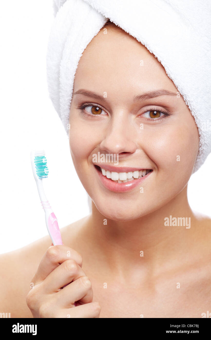 Happy woman with toothbrush looking at camera Stock Photo - Alamy