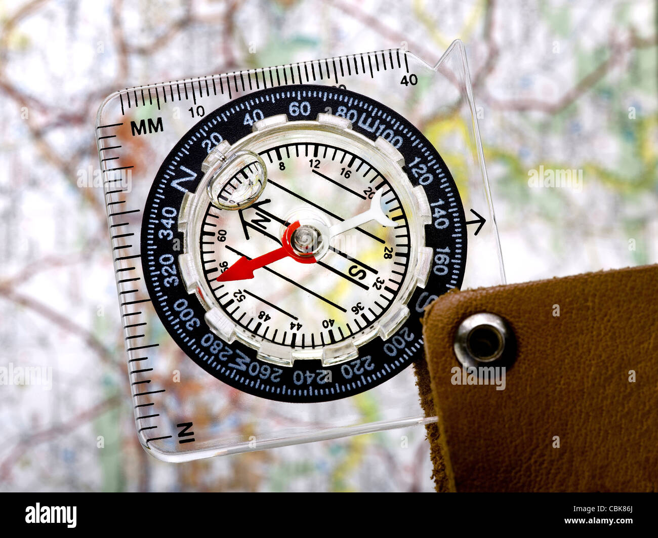 A clear plastic compass over a map Stock Photo - Alamy