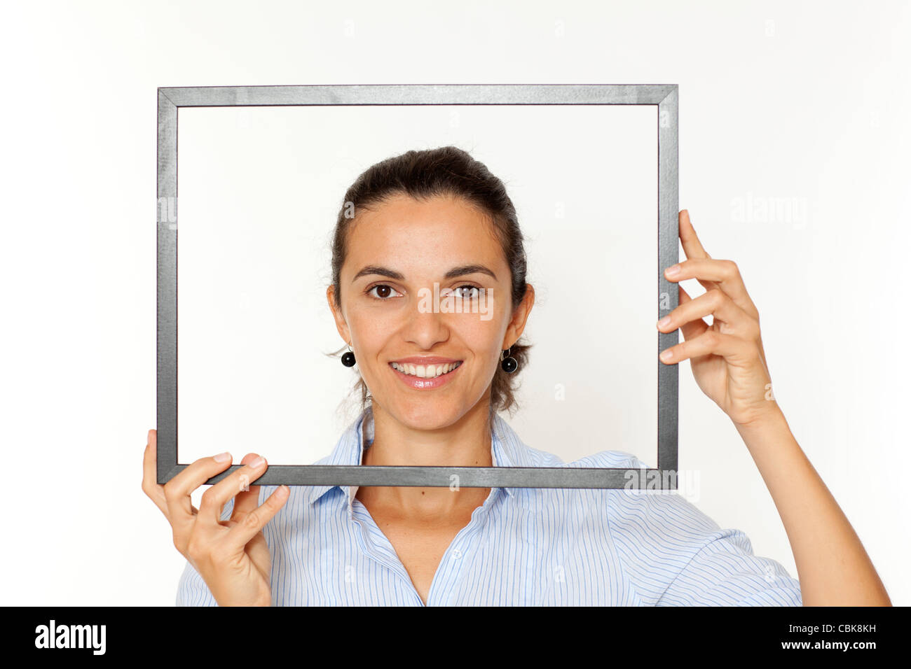 Pretty woman with a frame smiling Stock Photo - Alamy