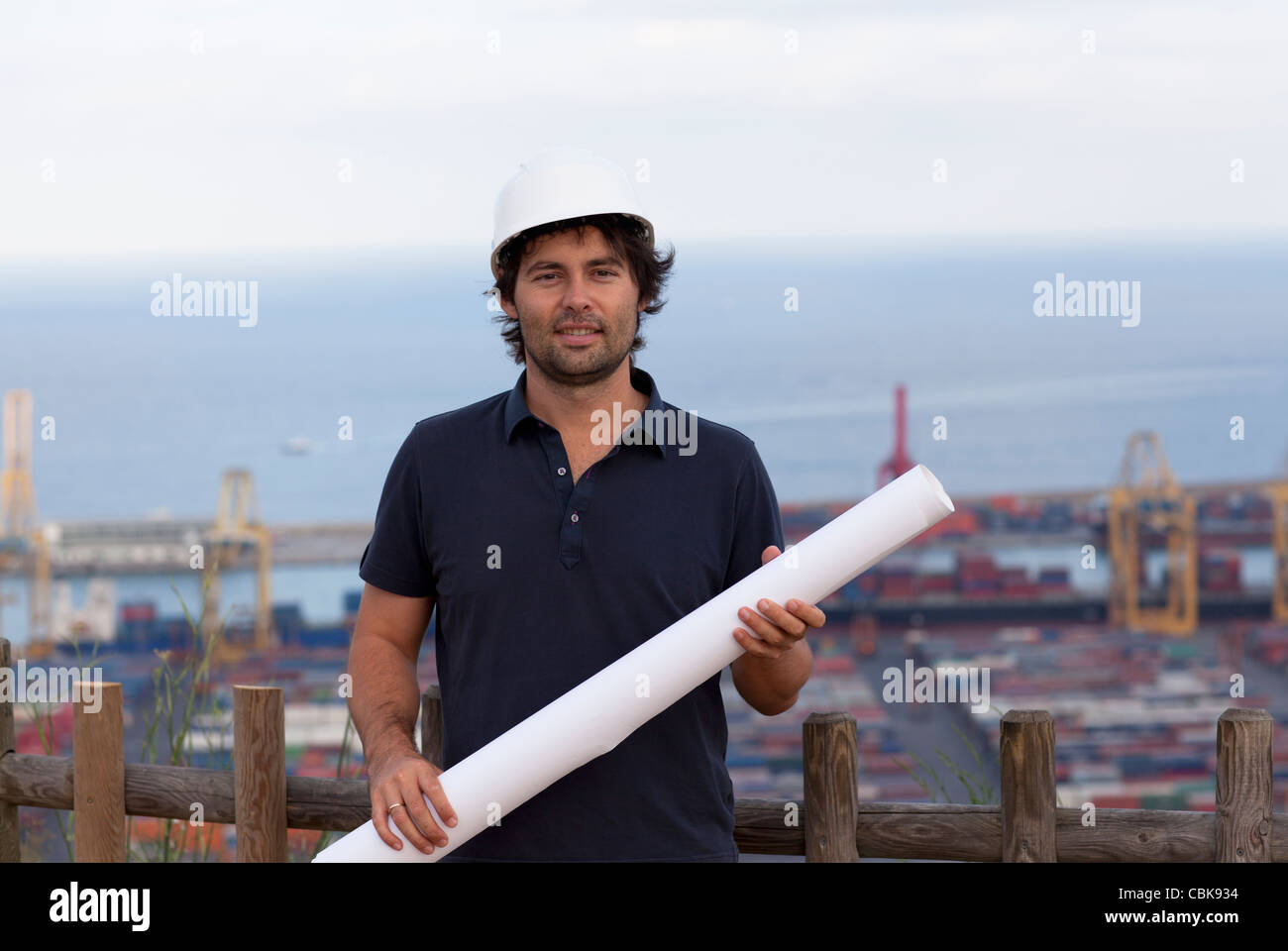 Male engineer checking a plan in front of a harbour Stock Photo - Alamy