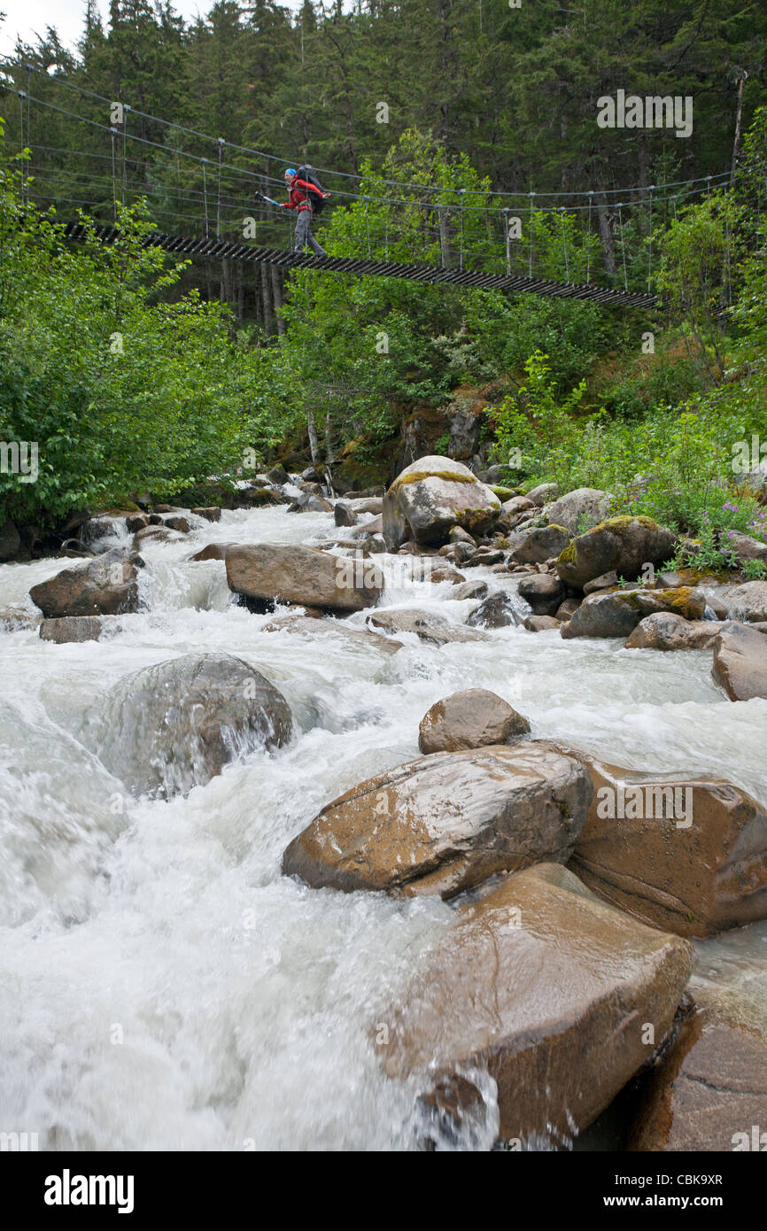 Backpacker crossing the Taiya river. Chilkoot Trail. Alaska. USA Stock ...
