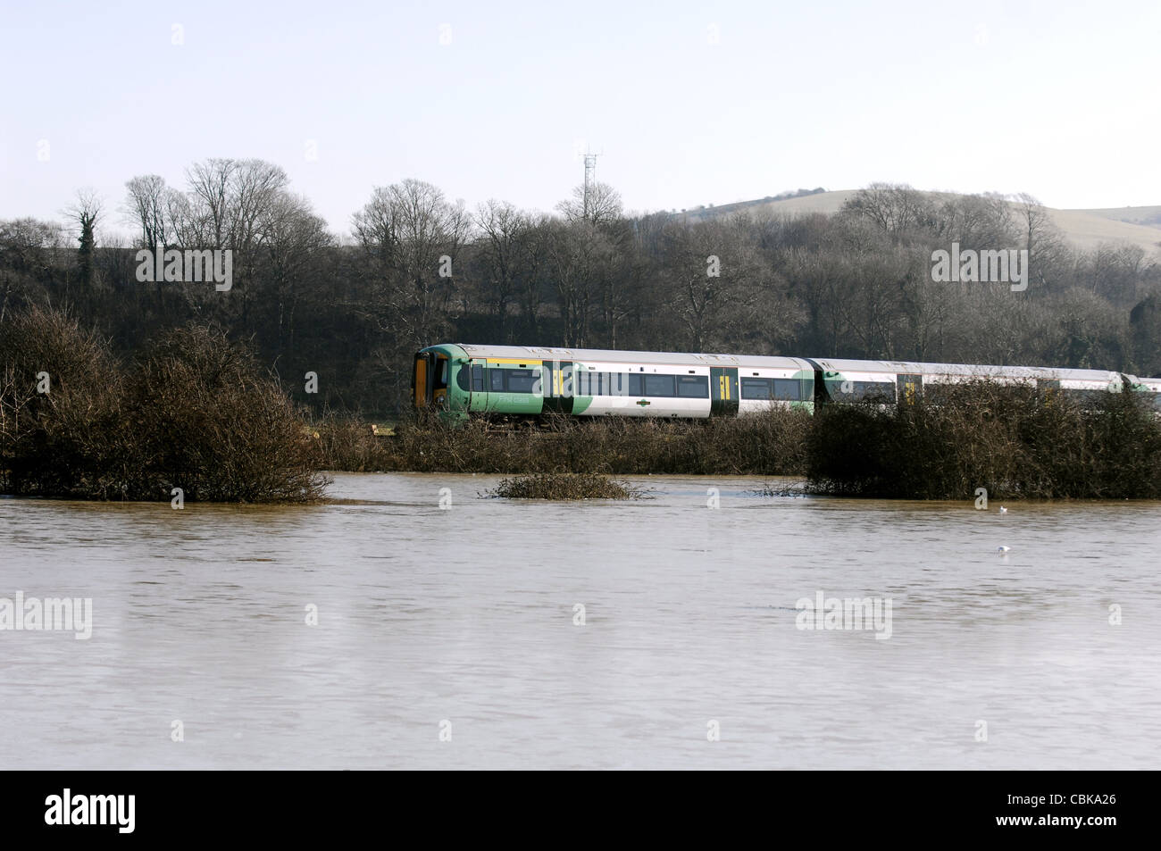 A train travels past floodwater in the Landport area of Lewes this ...