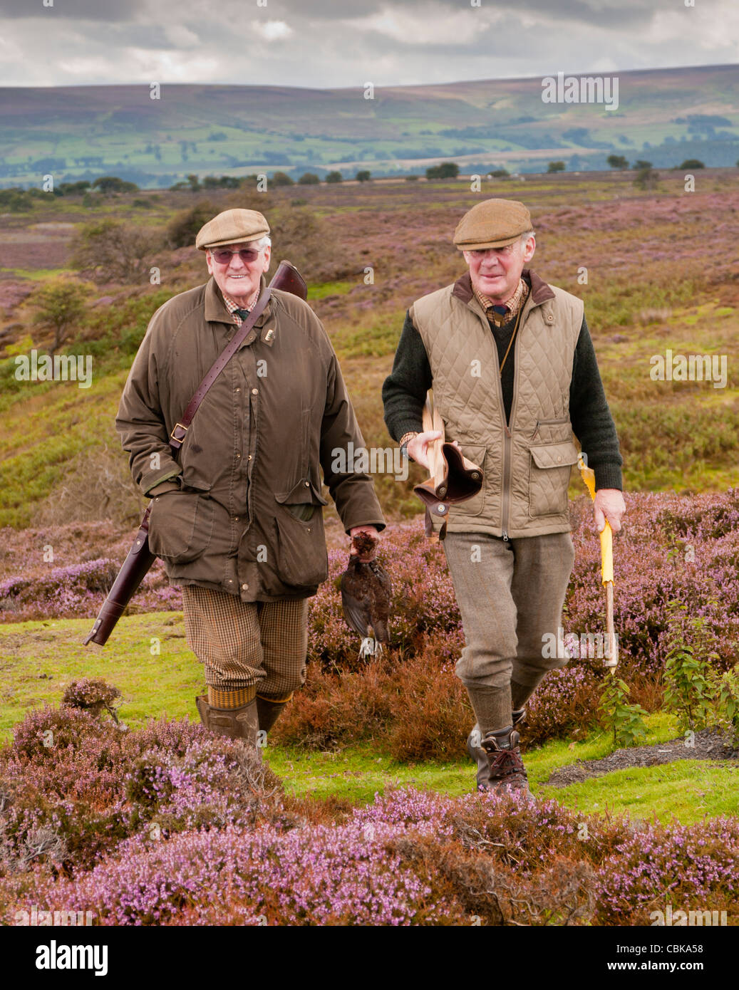 North Yorkshire, England UK - Two men, one carrying a red grouse ...