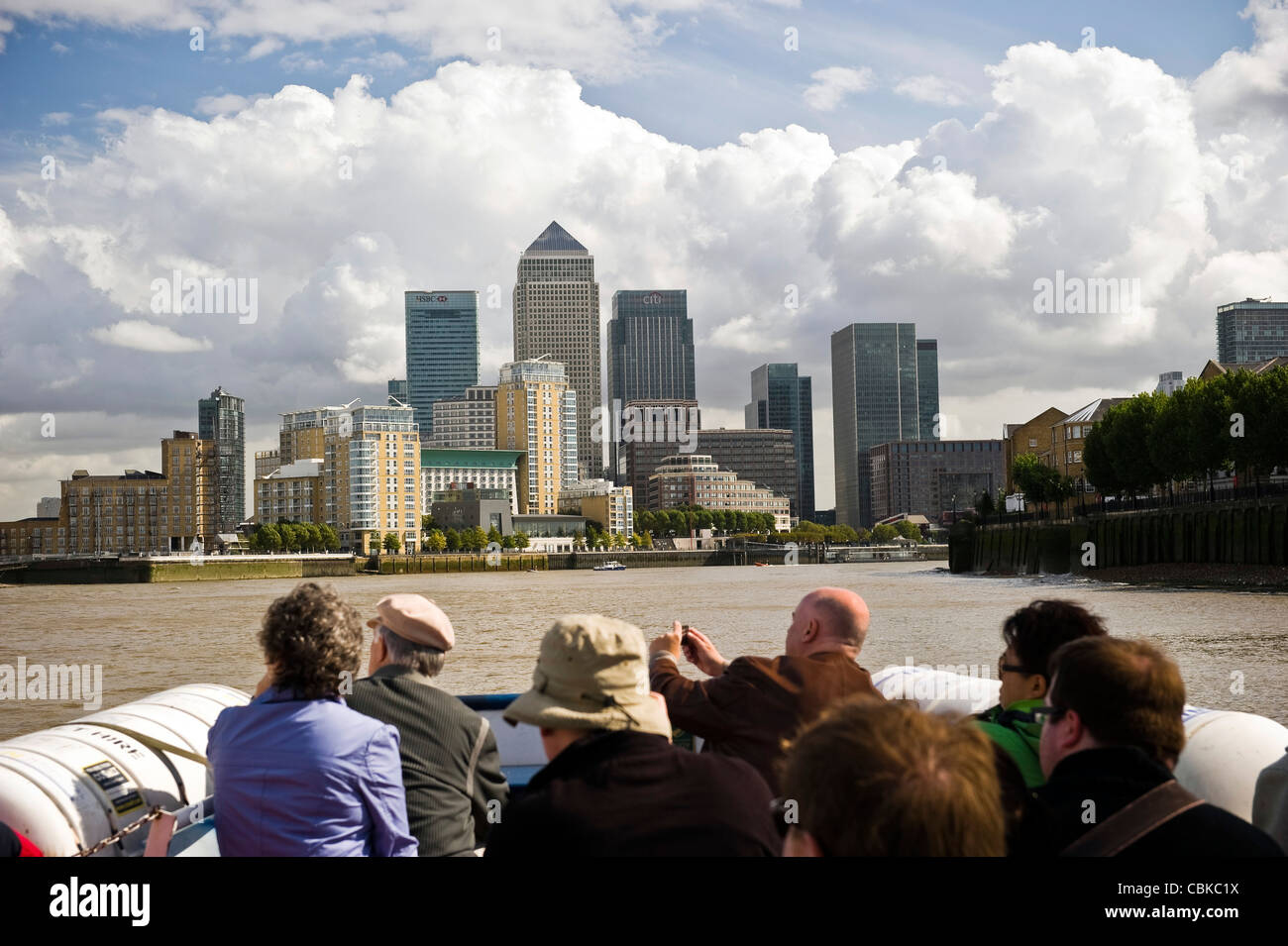 Sightseers on a Thames River boat guided tour viewing Docklands Canary ...
