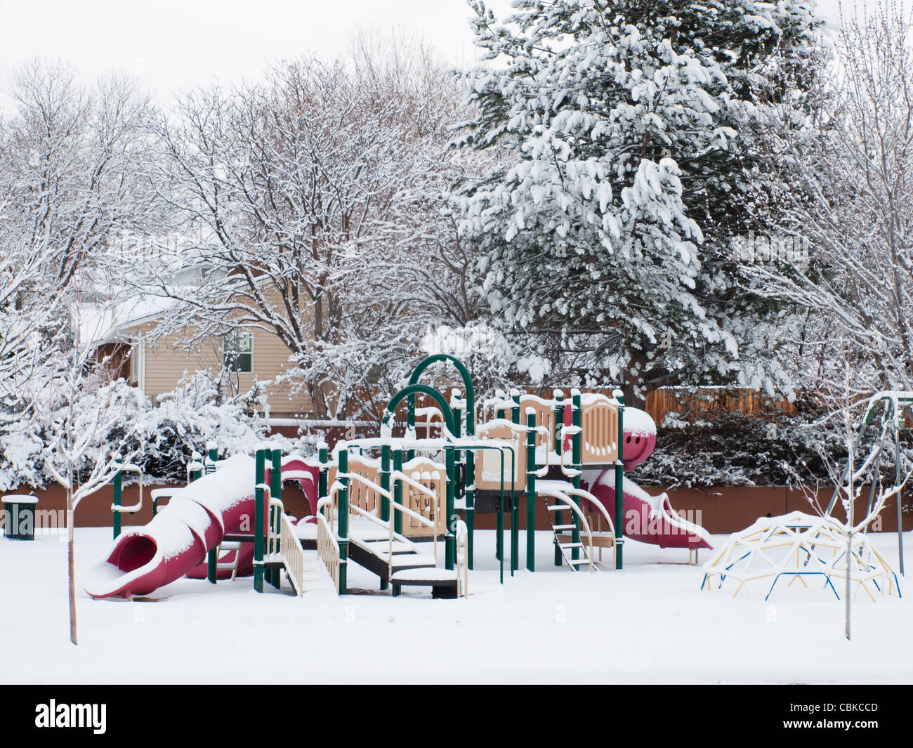 Kids playground in winter snow Stock Photo - Alamy