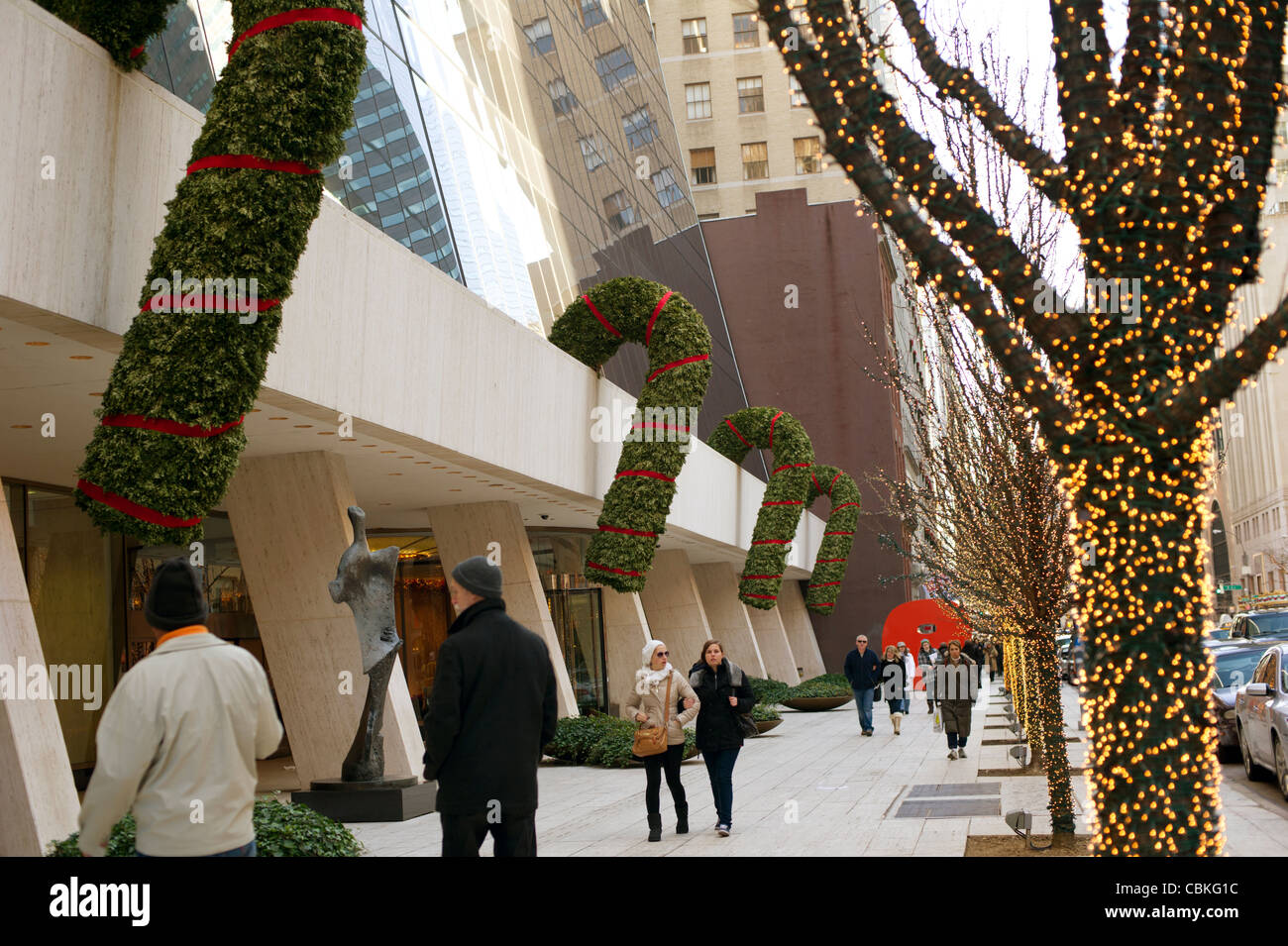 Pedestrians walk pass holiday decorations in midtown in New York on ...