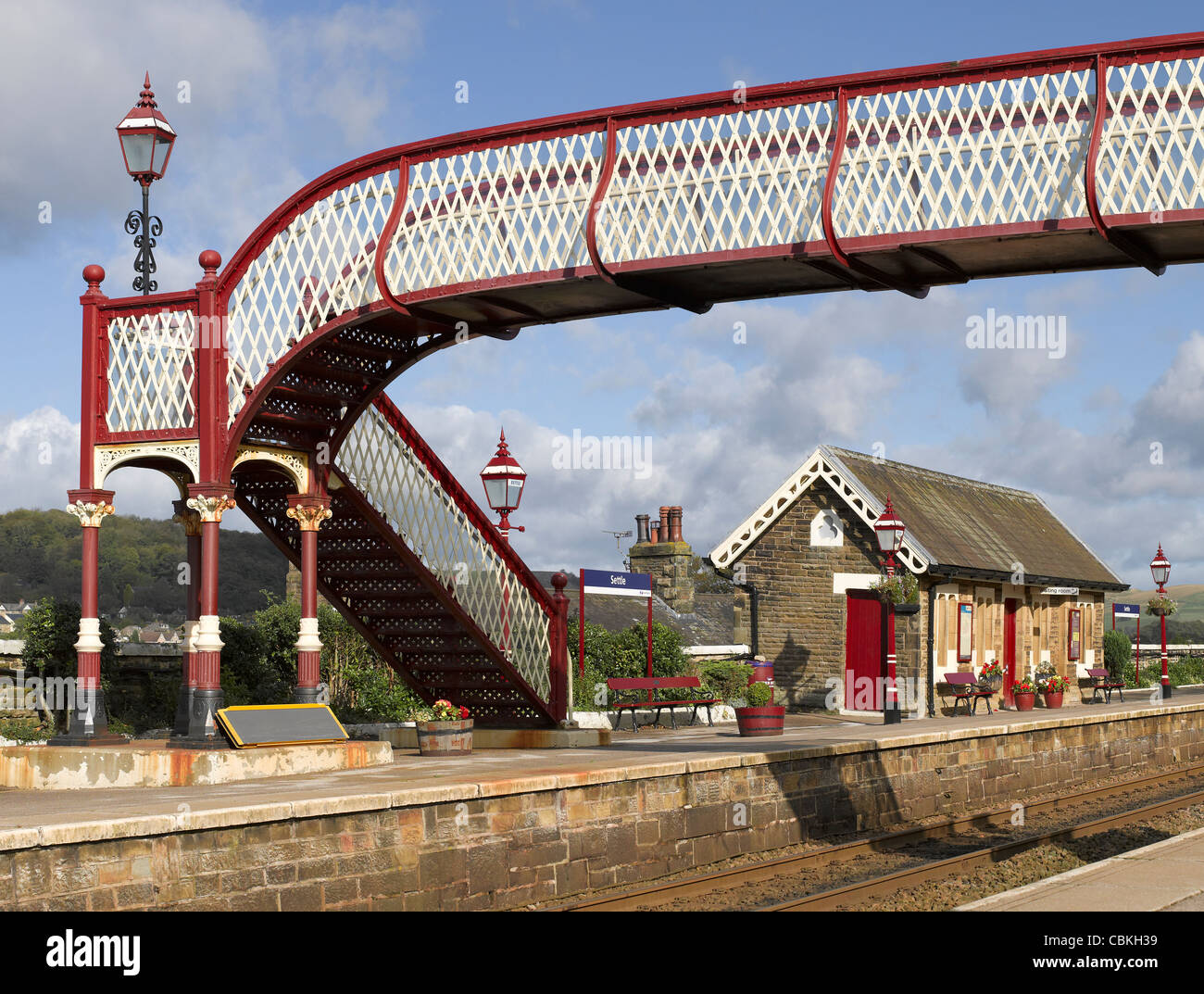 Footbridge bridge across the railway track at Settle train station ...