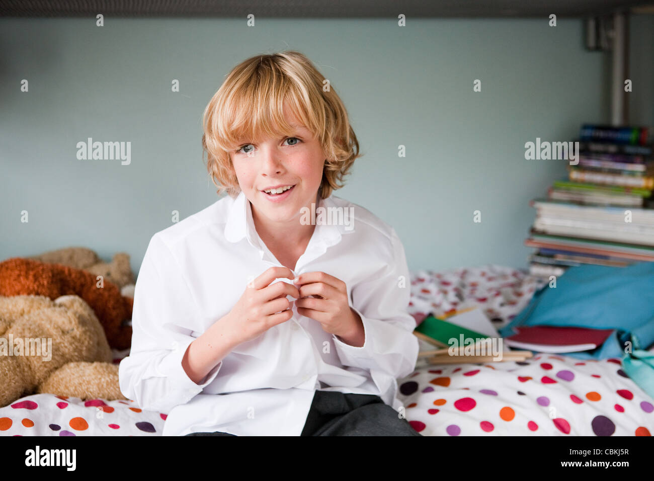 Boy buttoning shirt hi-res stock photography and images - Alamy