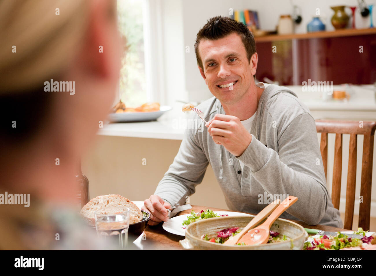 Couple eating healthy meal together at table Stock Photo - Alamy