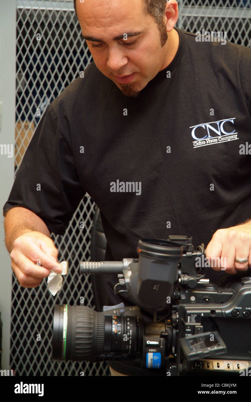 Nick Porter, cameraman for Al Jazeera English doing maintenance on ...