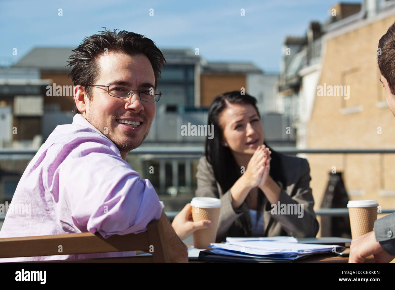 Three people in an outdoor meeting Stock Photo - Alamy