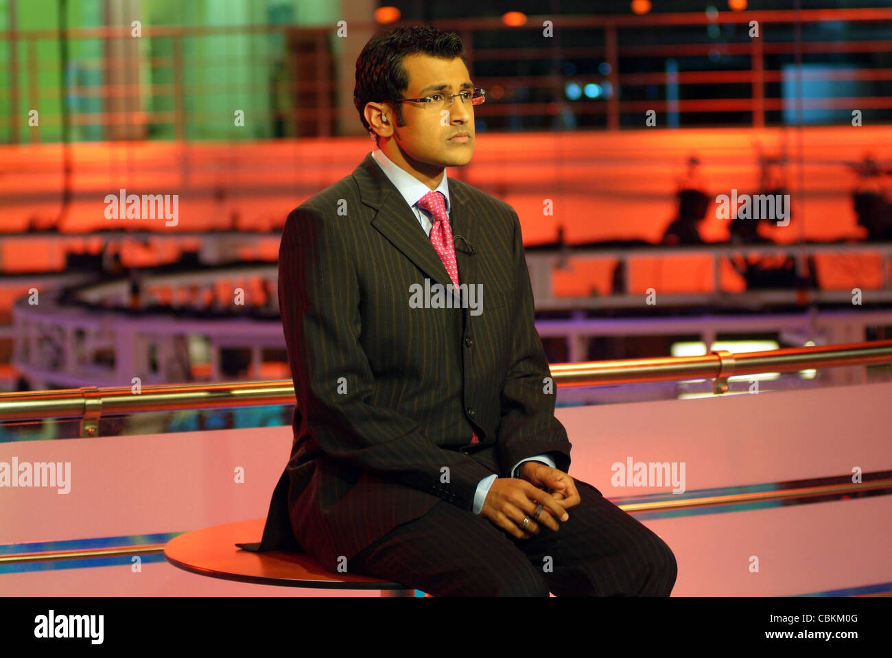 Al Jazeera English anchor delivering the news at the Doha HQ of AJE ...