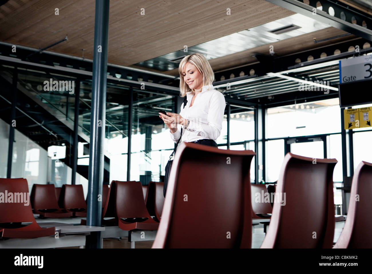 Woman smart phone in airport hi-res stock photography and images - Alamy
