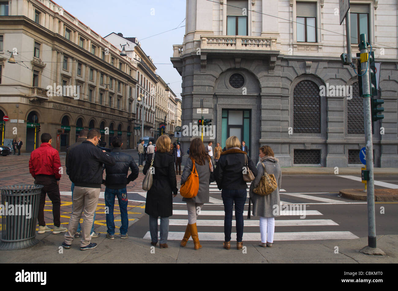 Pedestrians in traffic lights Piazza della Scala square Milan Lombardy ...