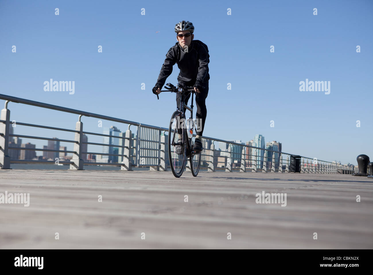 Man cycling over bridge Stock Photo - Alamy