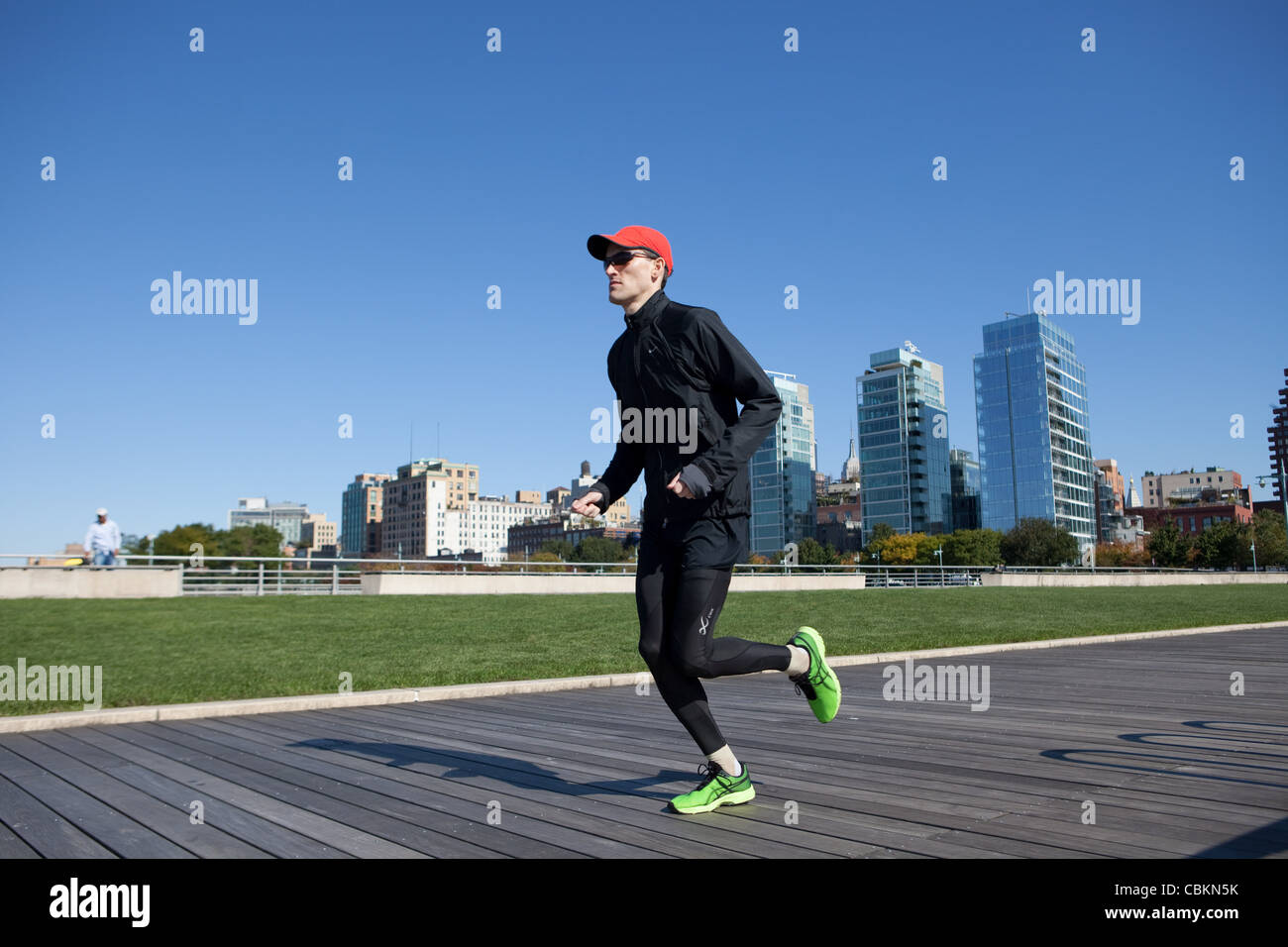Man jogging on timber walkway Stock Photo - Alamy