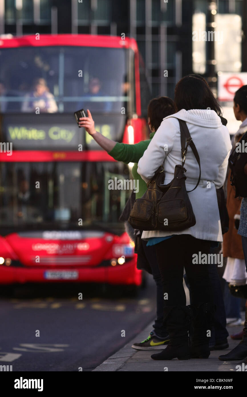 Woman bus stop queue hi-res stock photography and images - Alamy