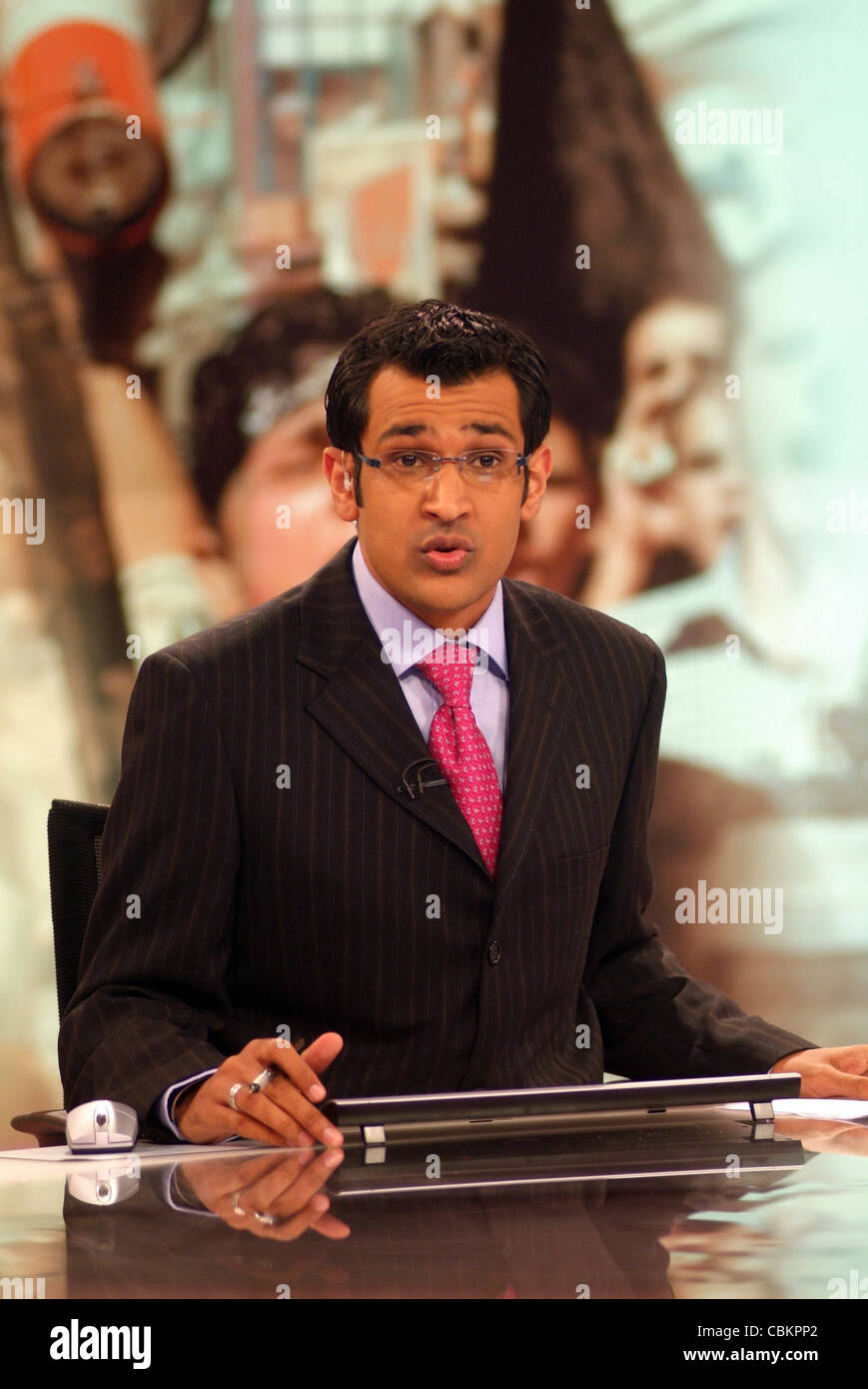 Al Jazeera English anchor delivering the news at the Doha HQ of AJE ...