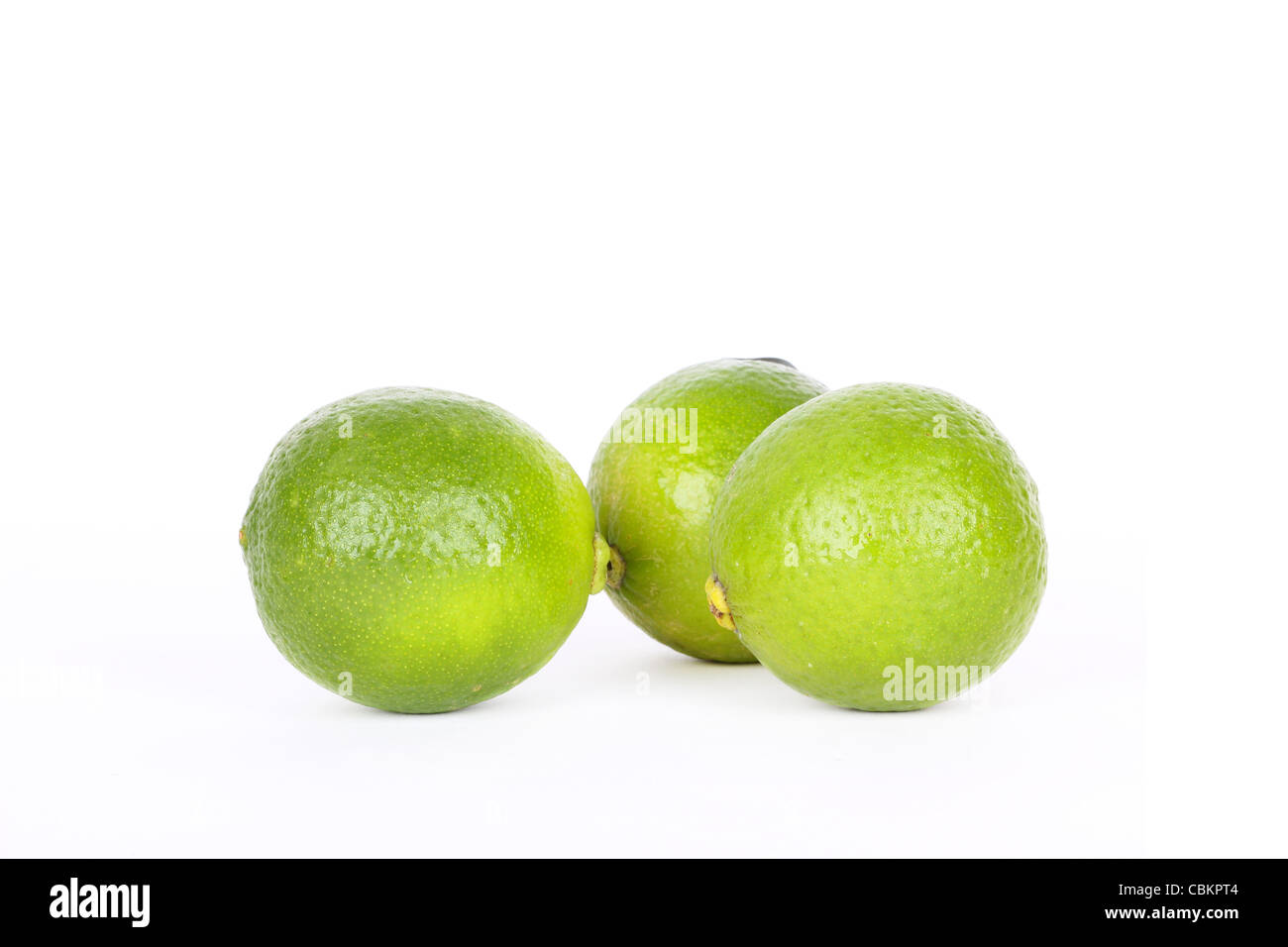 Three limes closeup on white background Stock Photo - Alamy