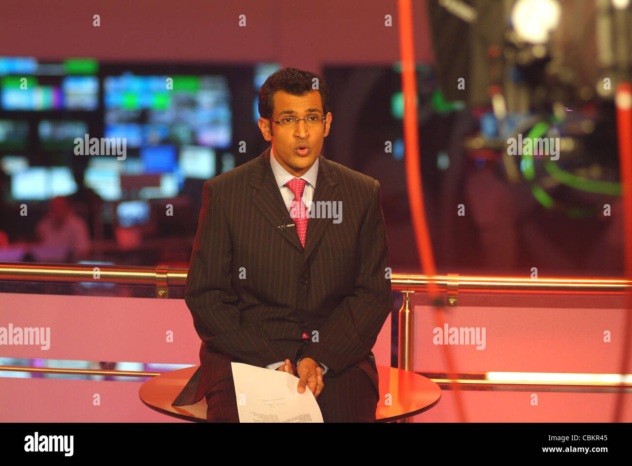 Al Jazeera English anchor delivering the news at the Doha HQ of AJE ...