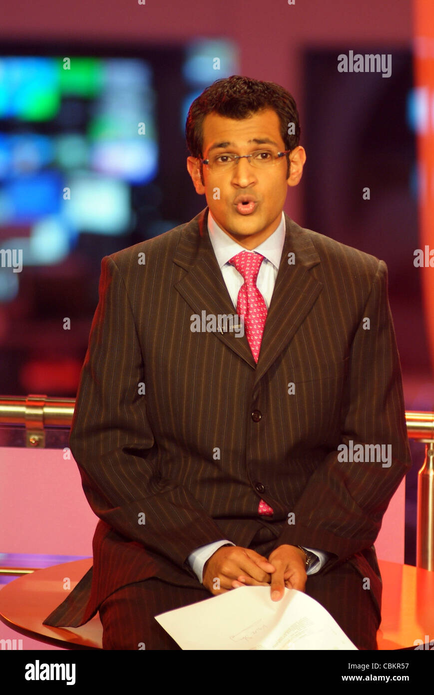 Al Jazeera English anchor delivering the news at the Doha HQ of AJE ...