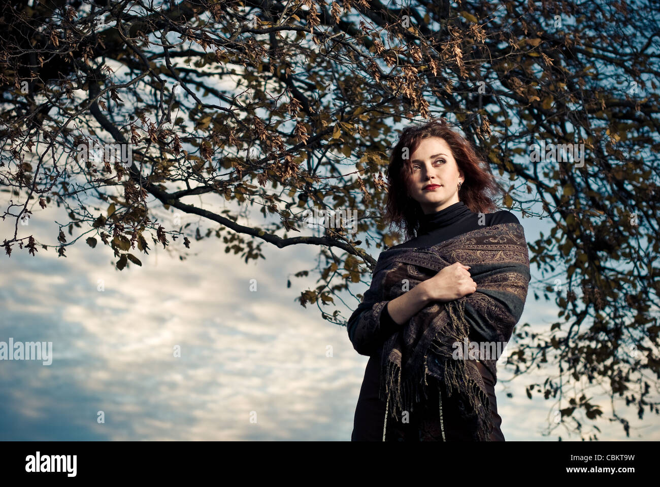 Woman under tree Stock Photo - Alamy