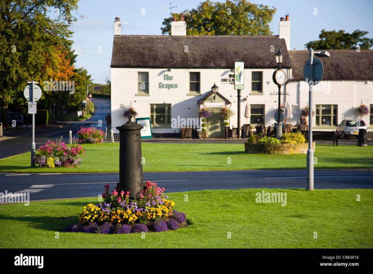 Ornamental water pump in front of The Grapes pub in village of Wrea ...