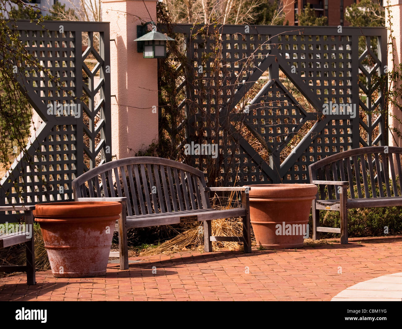 Wooden bench between large planters Stock Photo - Alamy