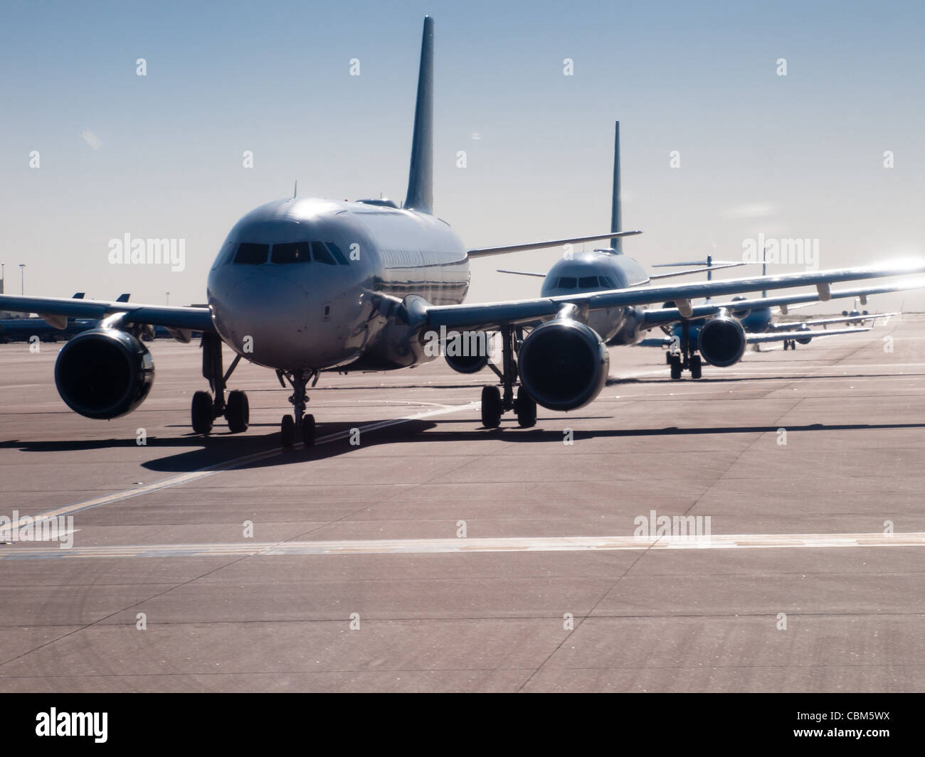 Airplanes lined up before departure Stock Photo - Alamy
