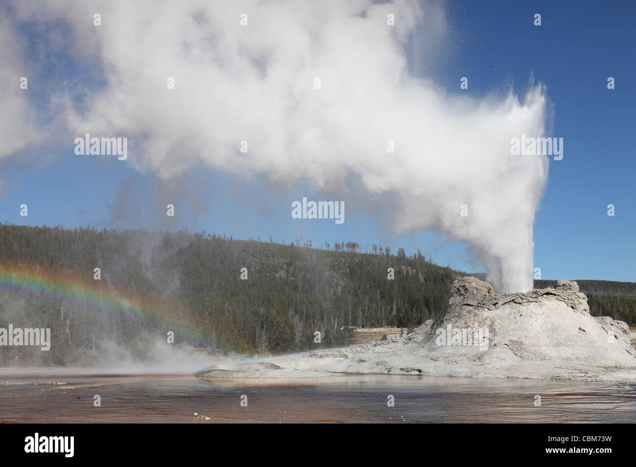 Castle Geyser eruption with rainbow, Upper Geyser Basin geothermal area ...