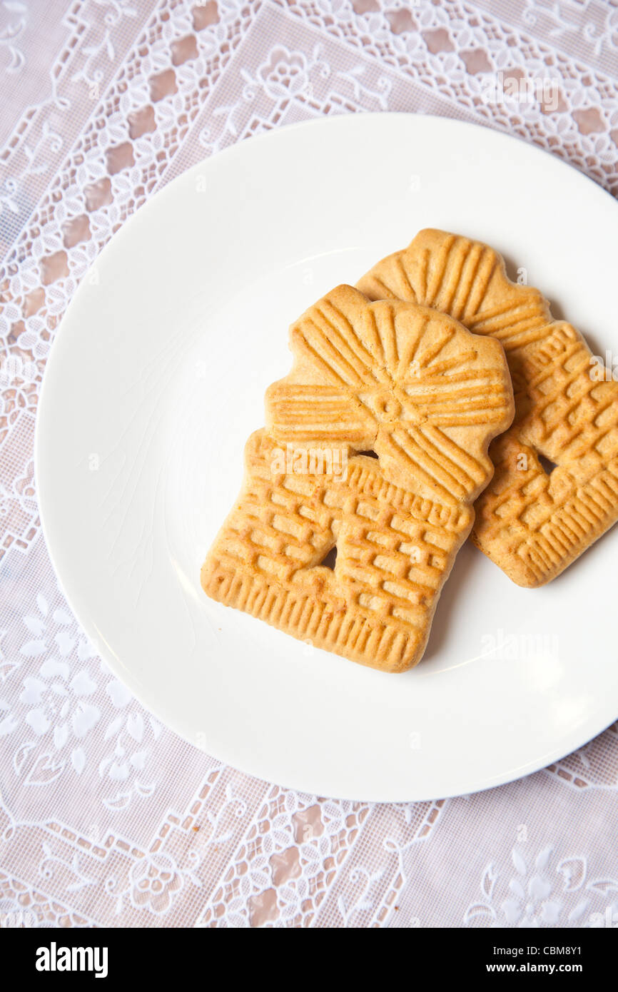 Dutch windmill cookie on dinner plate on table Stock Photo - Alamy