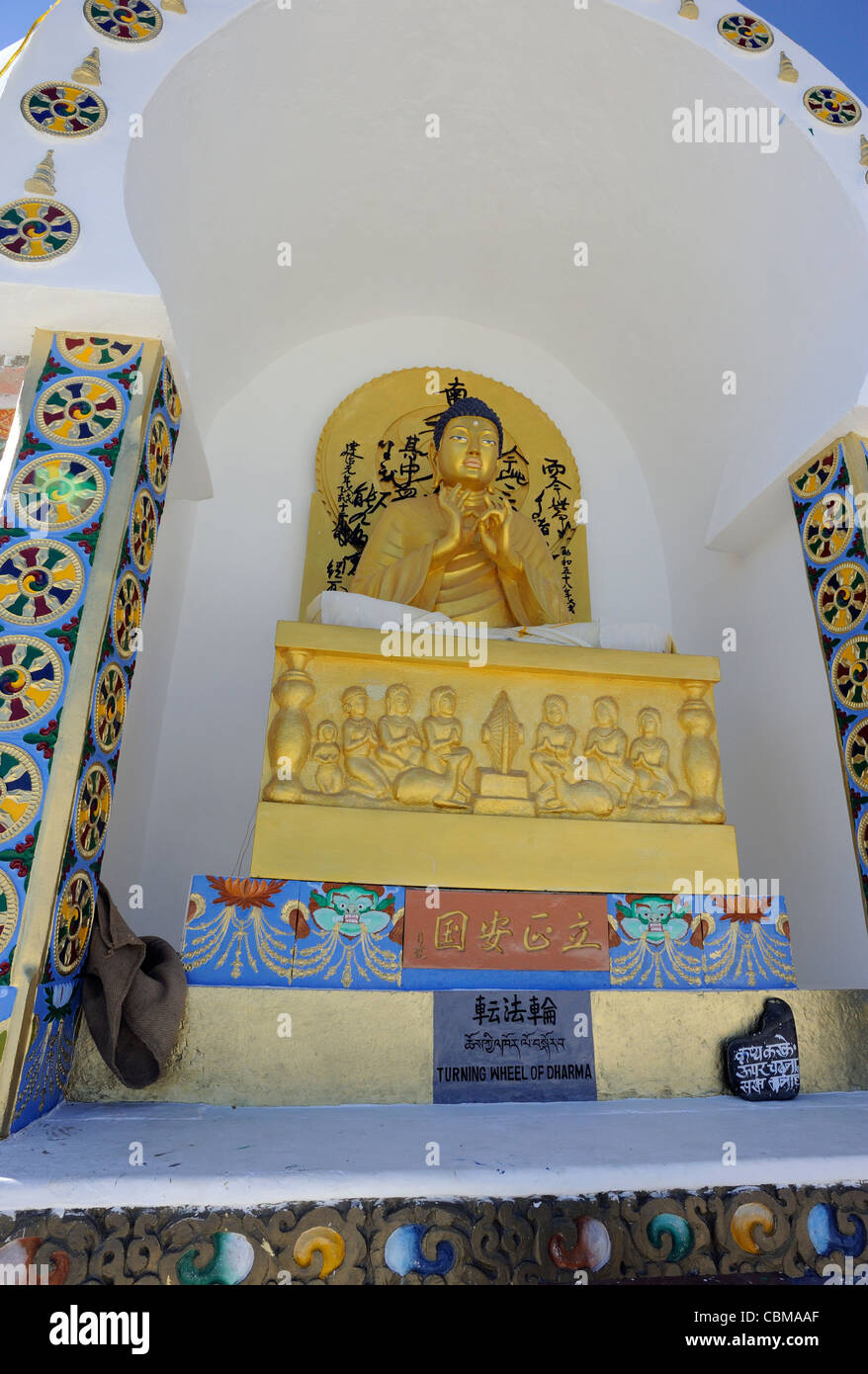 The main golden image of the Buddha on the dome of the Shanti Stupa ...