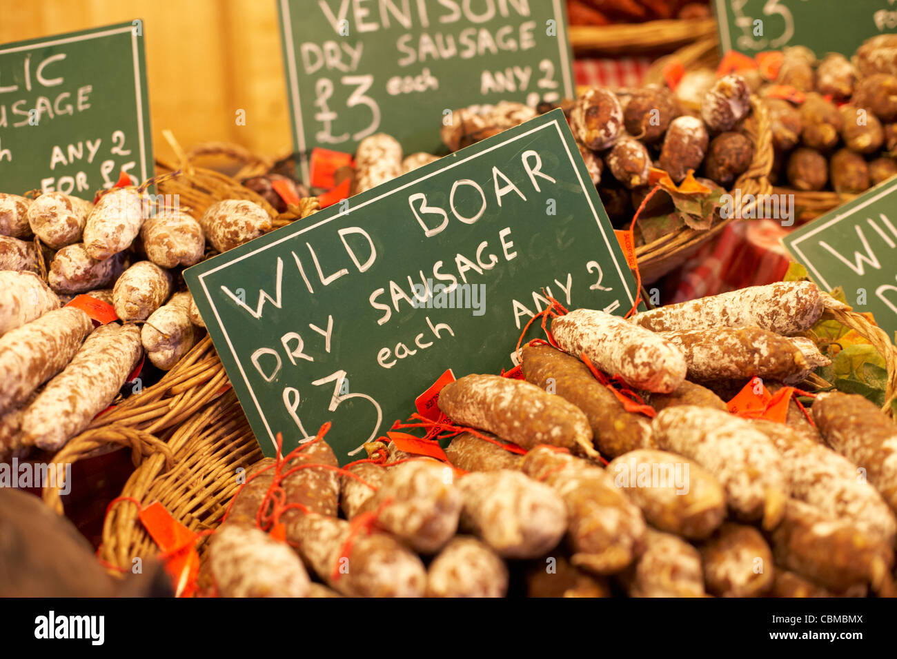 selection of dry cured meat sausages including wild boar on a stall in ...