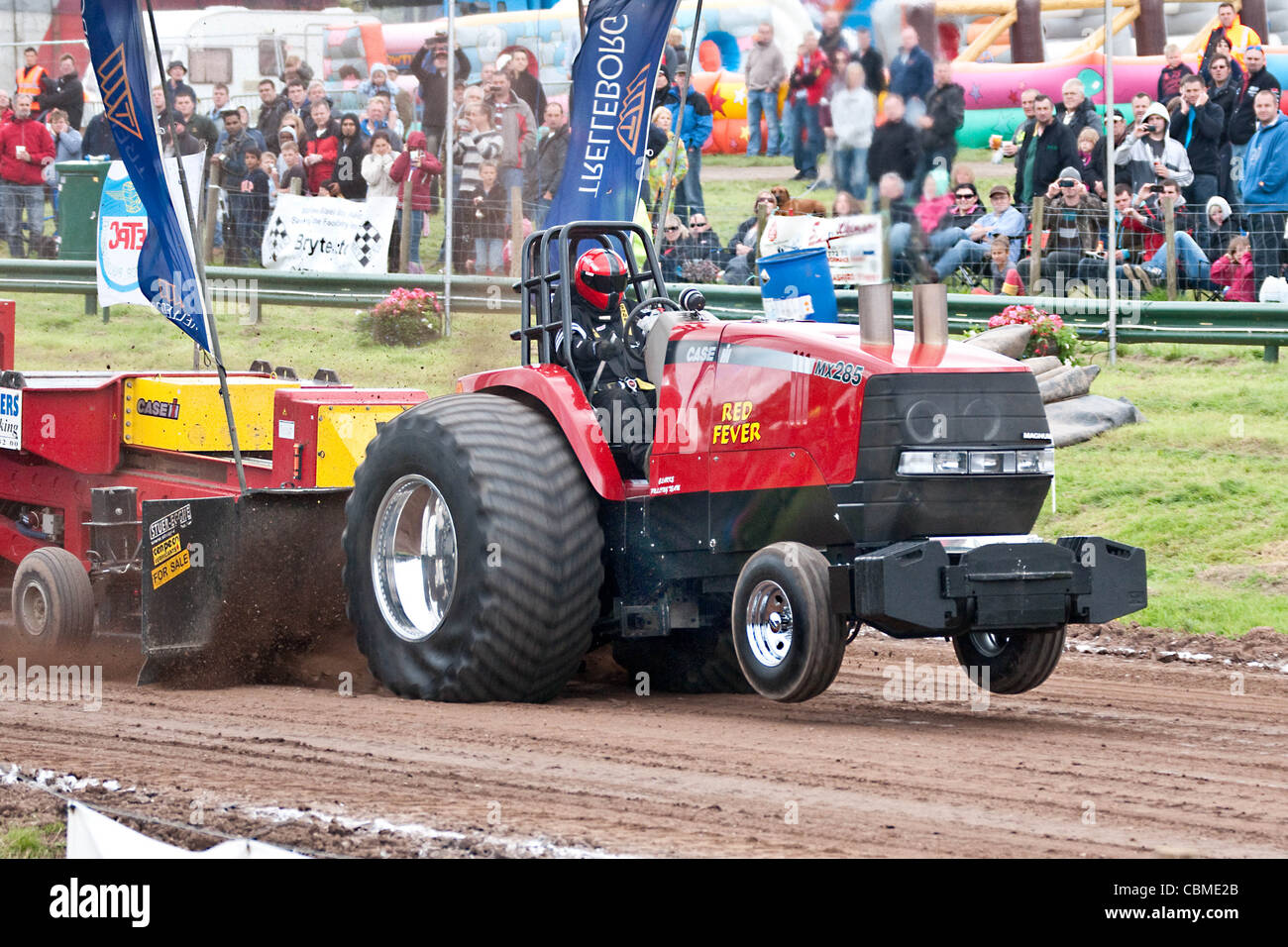 Specially-modified tractor strains to haul a weight-shifting sled in a ...