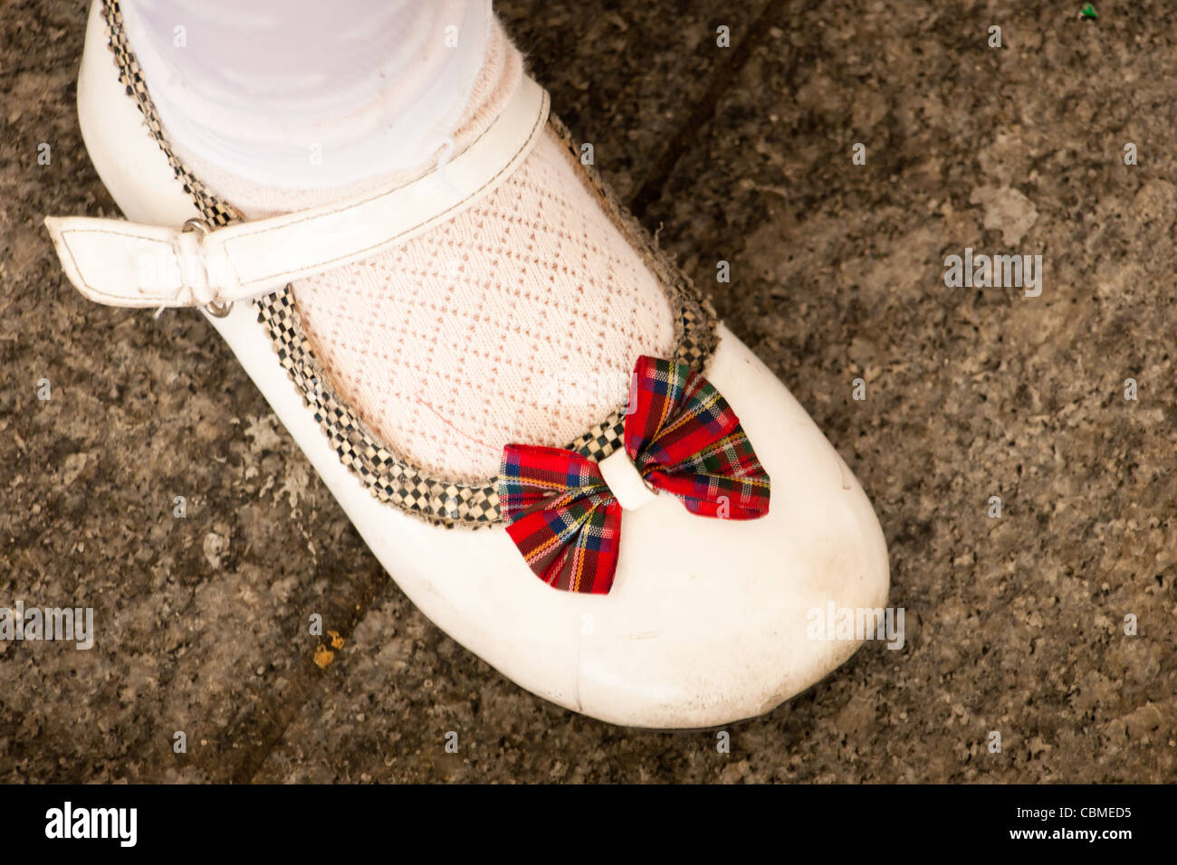 Girls shoe with the red bow Stock Photo - Alamy