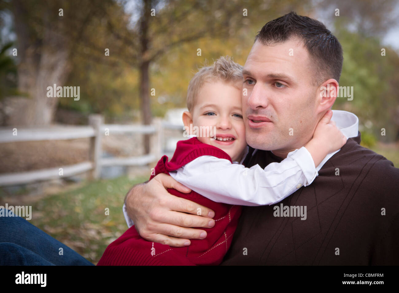 Handsome Father and Son Embracing in the Park Stock Photo - Alamy
