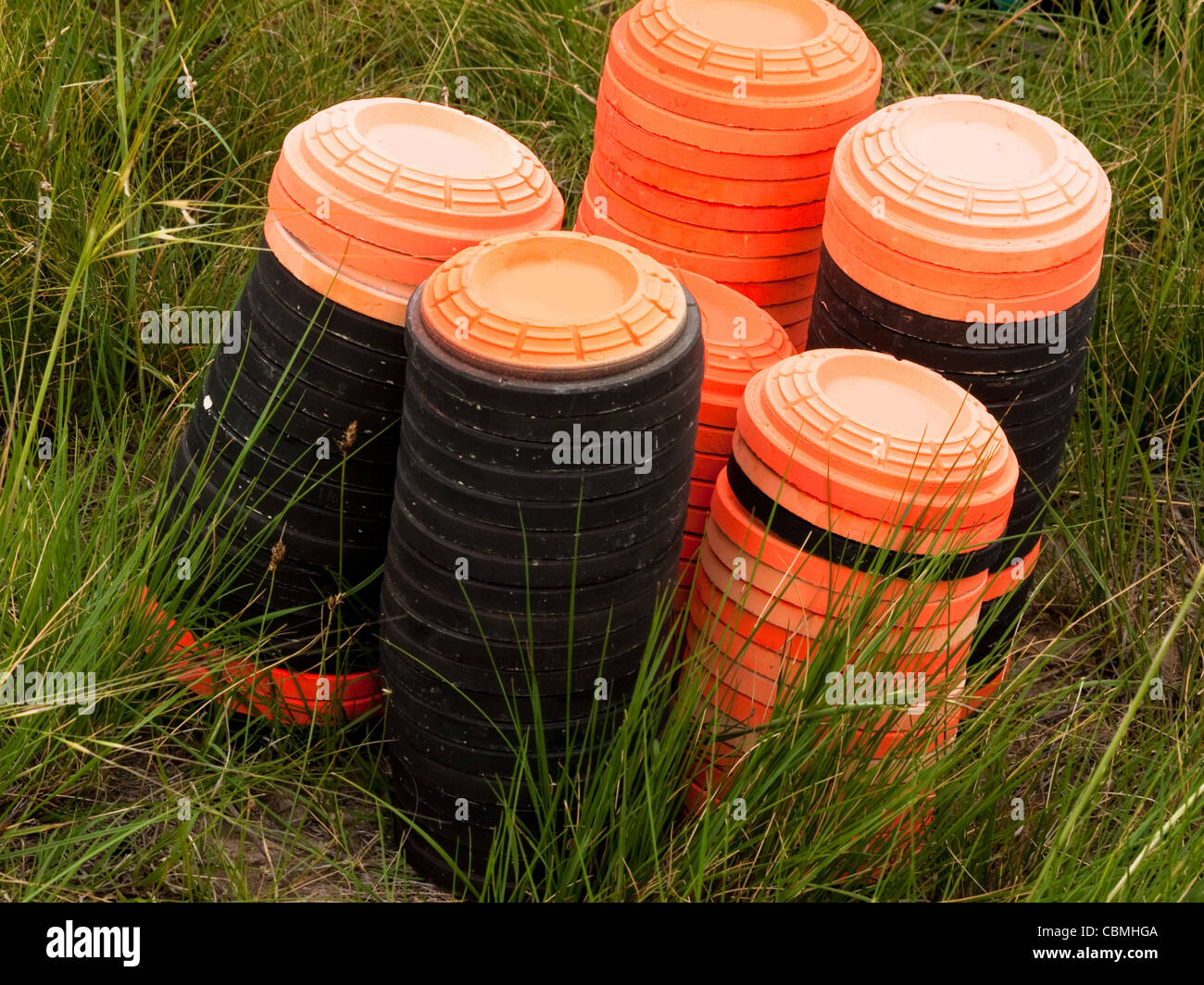 Stack of orange clay pigeon Stock Photo - Alamy