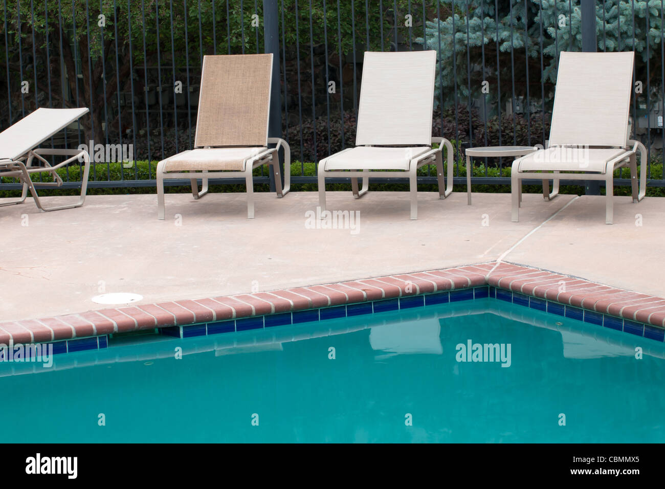 Swimming pool with chairs Stock Photo - Alamy