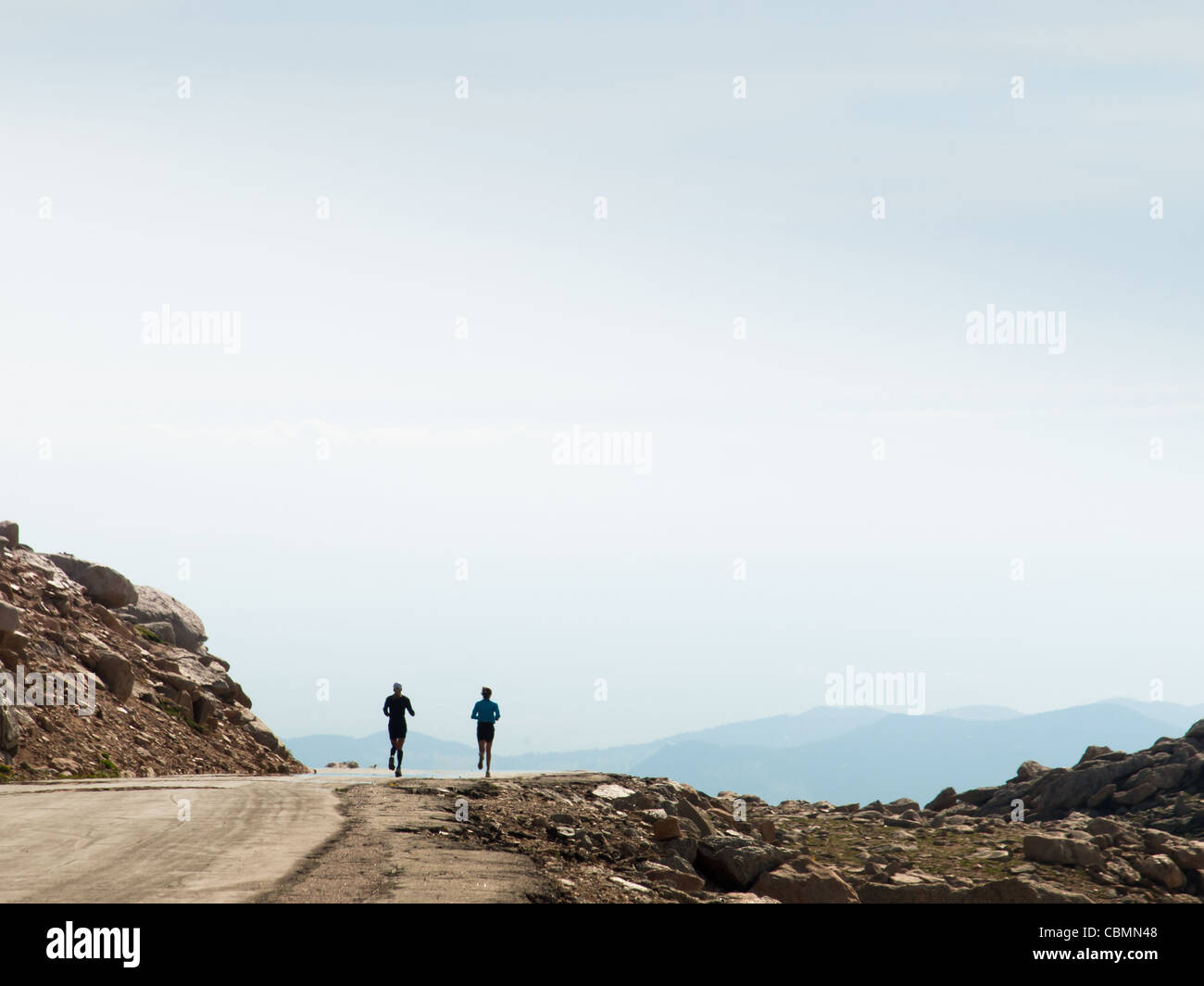 Two runners on the mountain road Stock Photo - Alamy