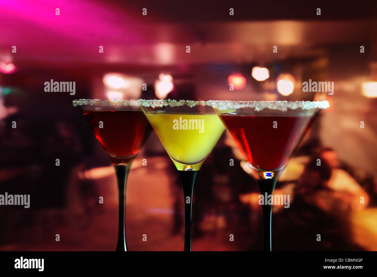 Three glasses with a cocktail in bar Stock Photo - Alamy