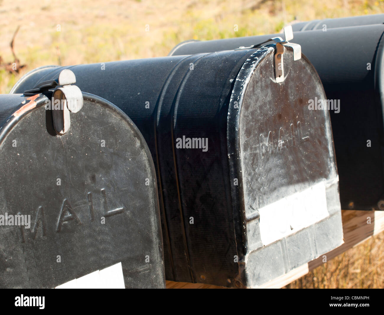 Row of black mailboxes Stock Photo - Alamy