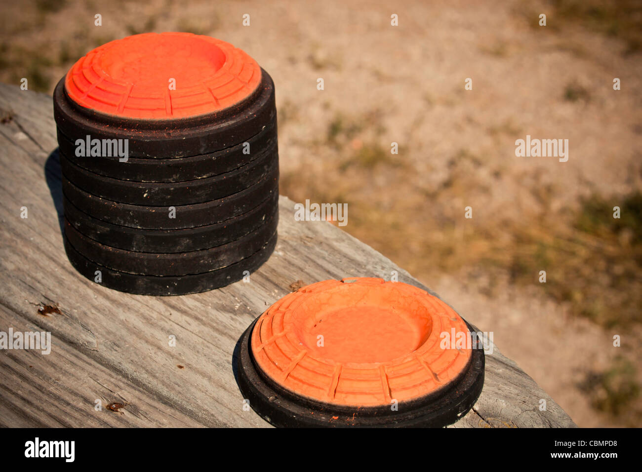 Stack of orange clay pigeons Stock Photo - Alamy