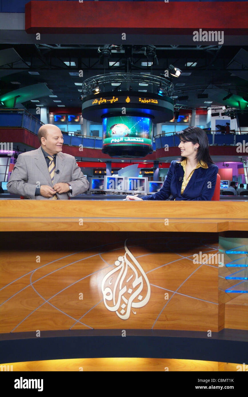 Al Jazeera satellite TV anchors Habib Ghribi and Lina Zahreddine read a ...